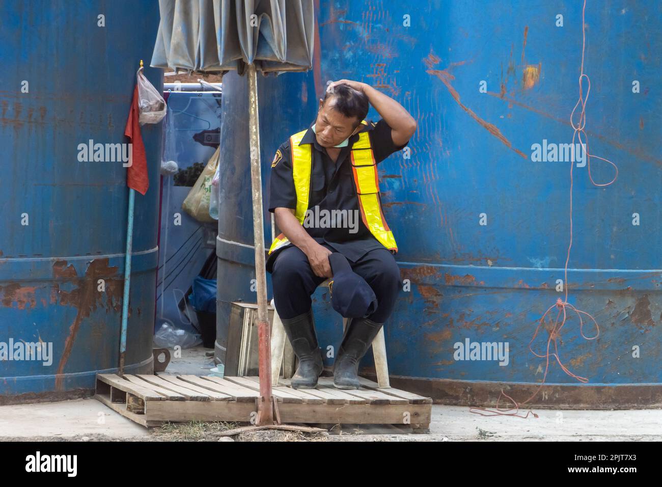 BANGKOK, THAILAND, JAN 28 2023, Tired security guard at construction ...