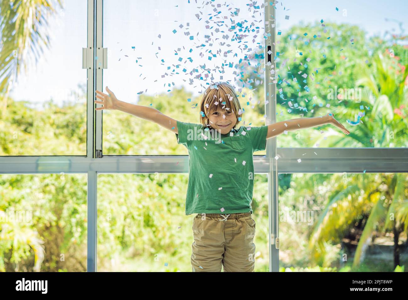 Happy Little happy cute boy throwing colorful confetti Stock Photo - Alamy