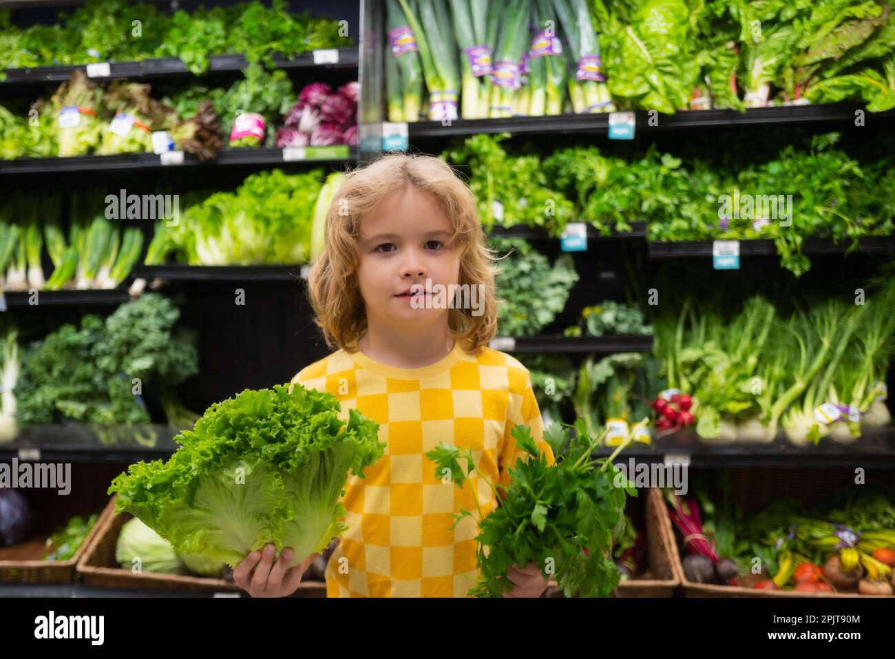 Child with lettuce chard vegetables. Shopping with kids. Kid buying ...