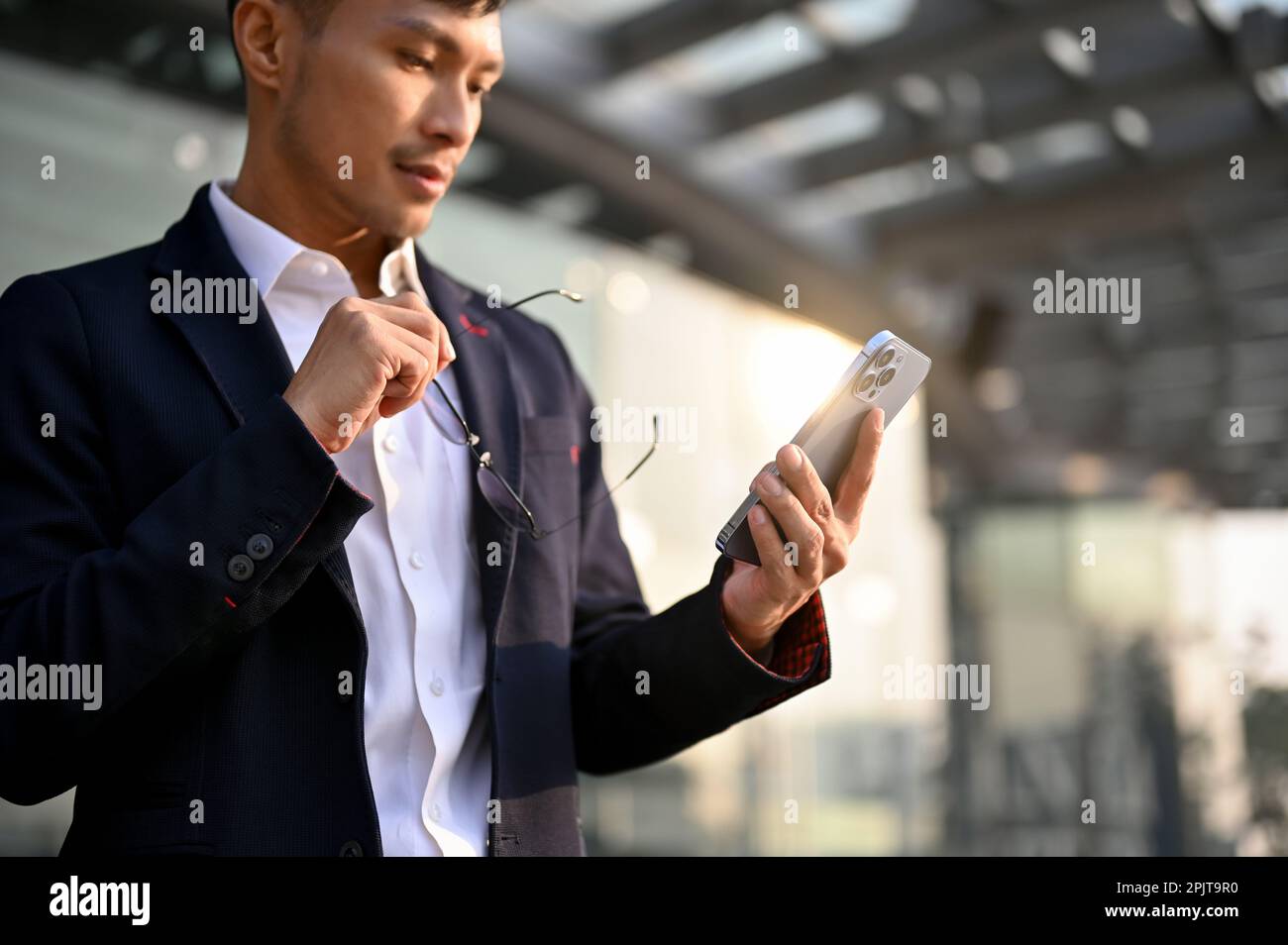 Successful and handsome millennial Asian businessman or male CEO in ...