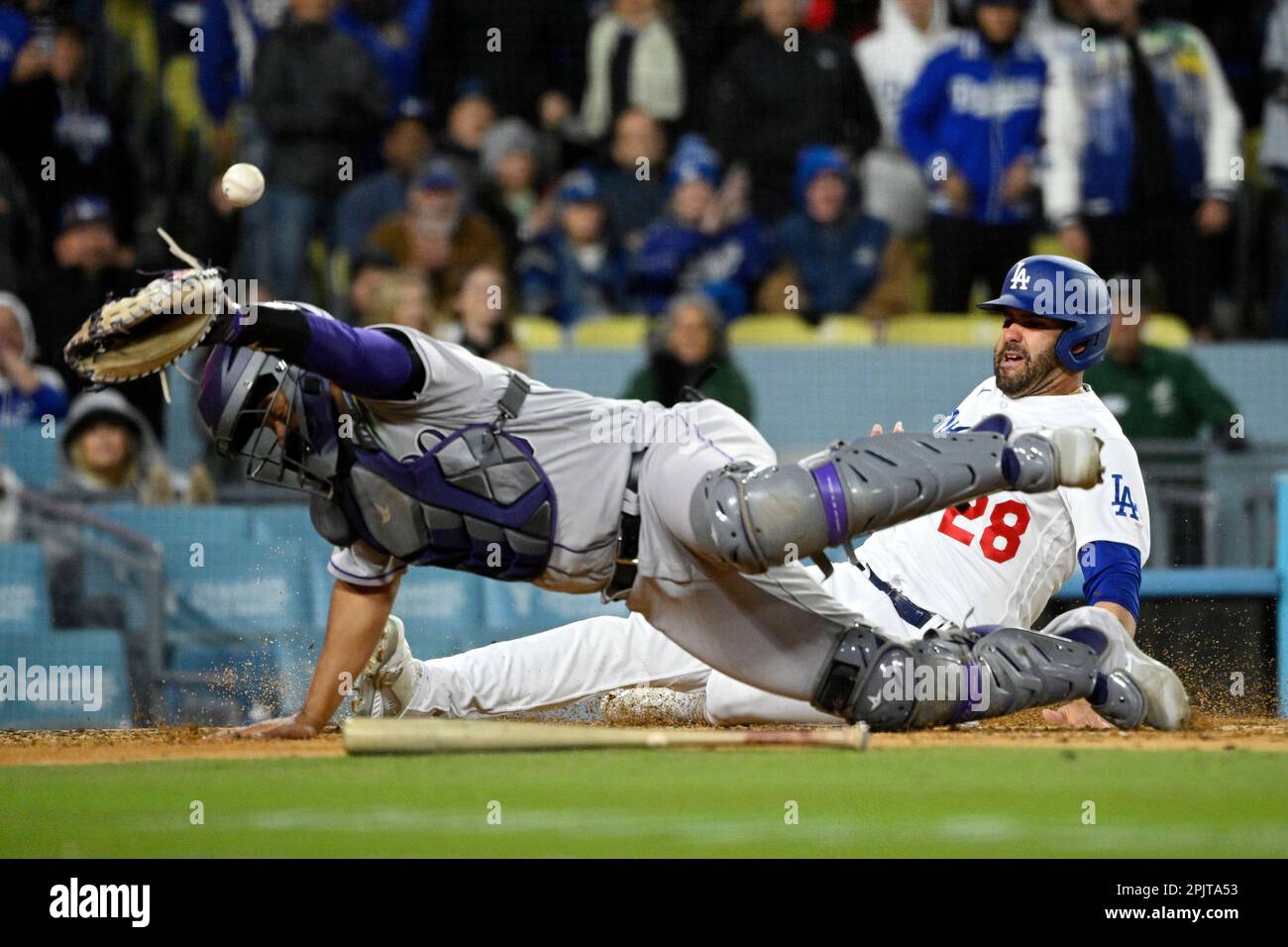 Los Angeles Dodgers' J.D. Martinez, right, scores on a triple by James ...