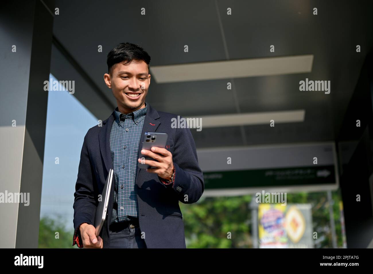 Busy and professional millennial Asian businessman checking messages on ...