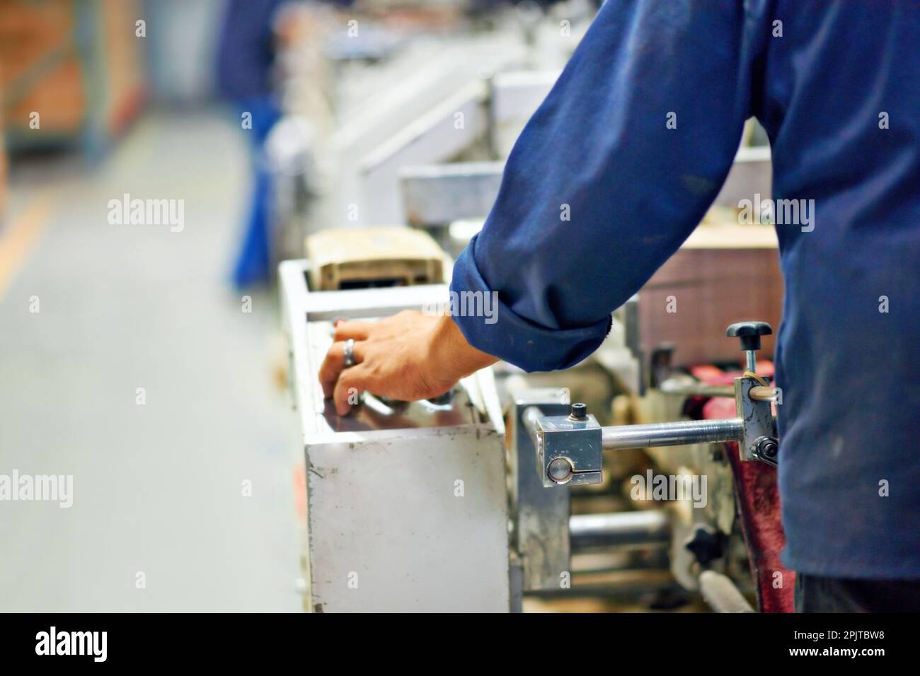 Operating the machine with accuracy. Cropped image of a factory worker ...