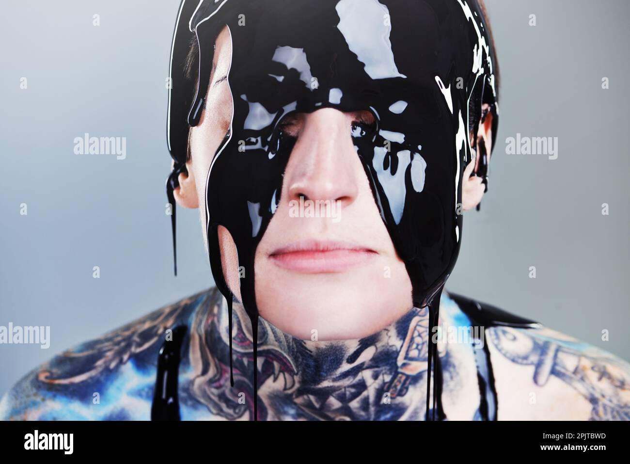 Never too much ink. Cropped image of a woman with black ink pouring ...