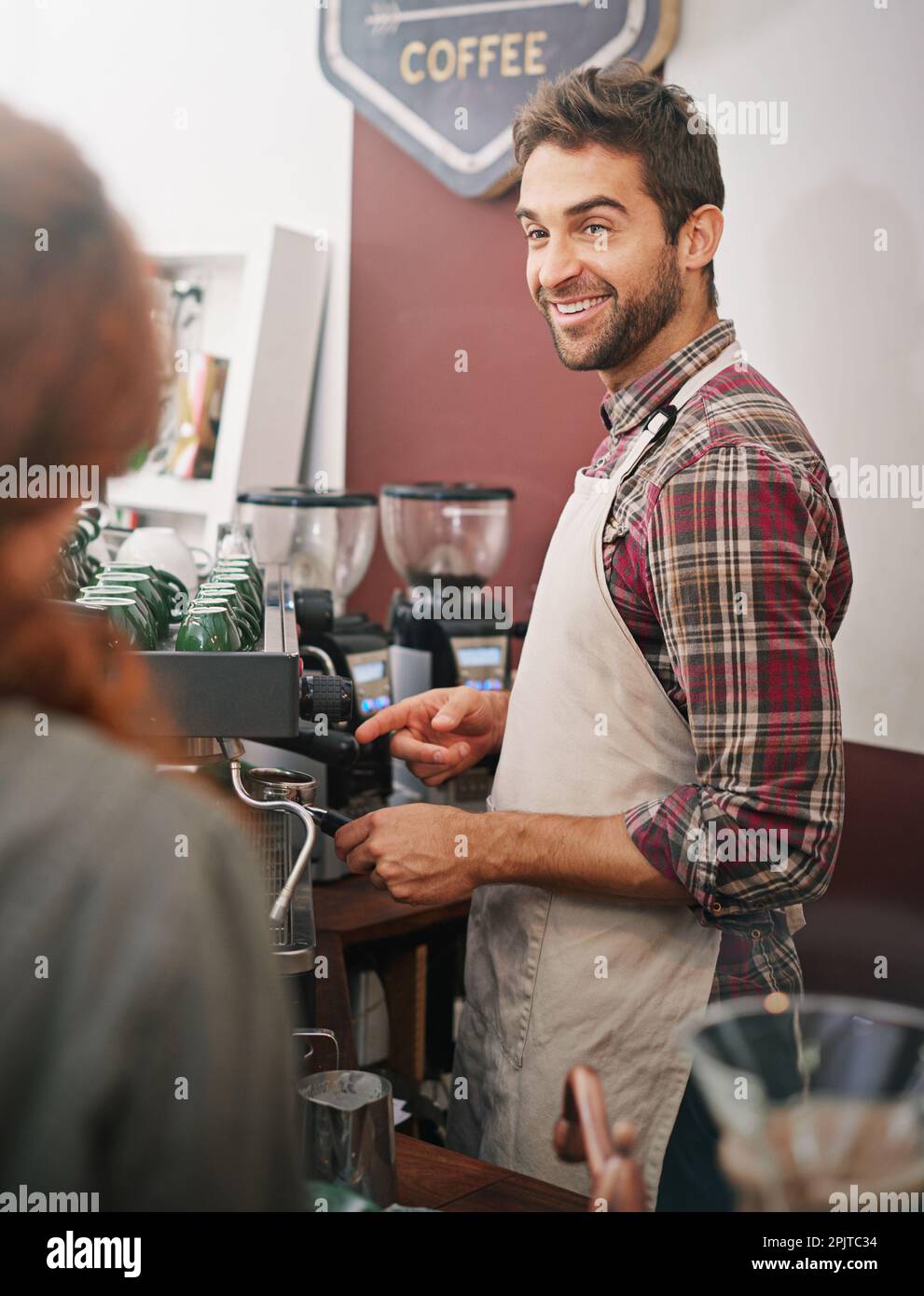 Coming right up. a young male barista serving a customer Stock Photo ...