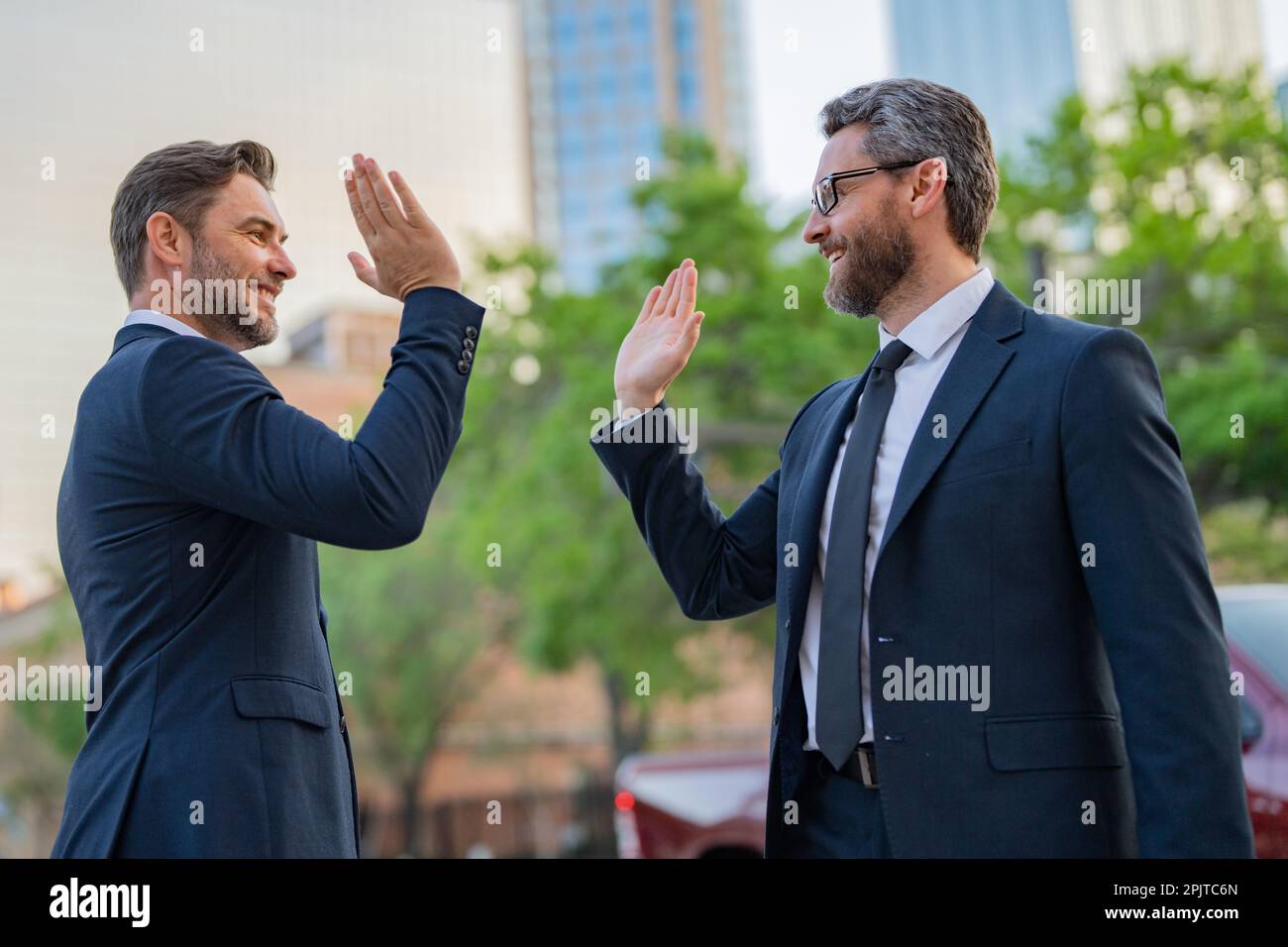 Business man shaking hands, high five sign. Two businessmen handshake ...