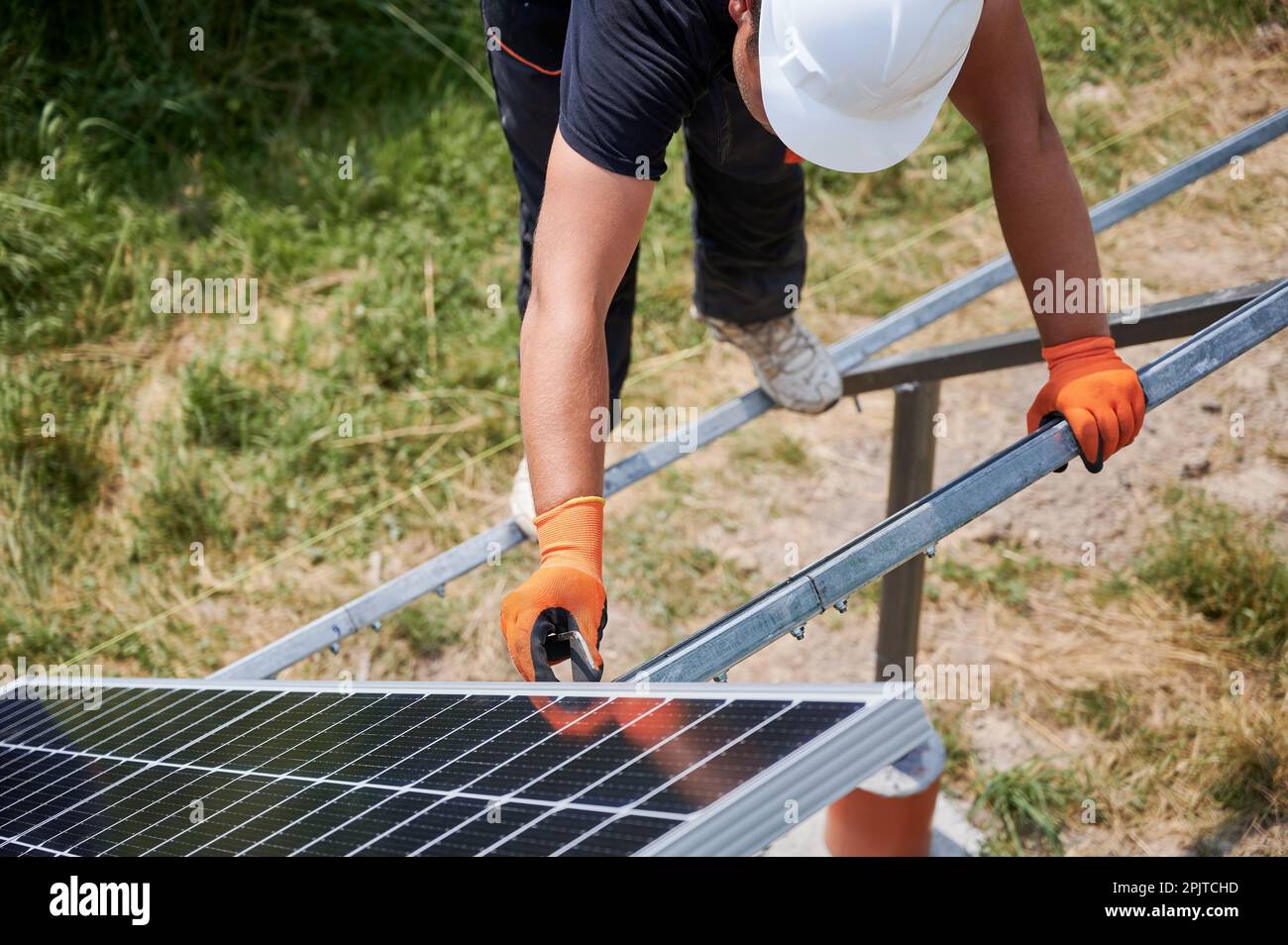 Male worker mounting photovoltaic solar panel system outdoors. Man ...