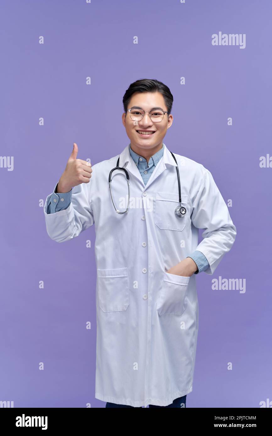 Portrait of a friendly doctor smiling giving thumbs up Stock Photo - Alamy