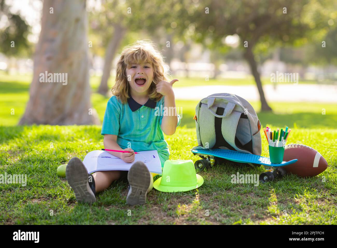 Kid painter draw on playground. School boy in park outdoor doing school ...