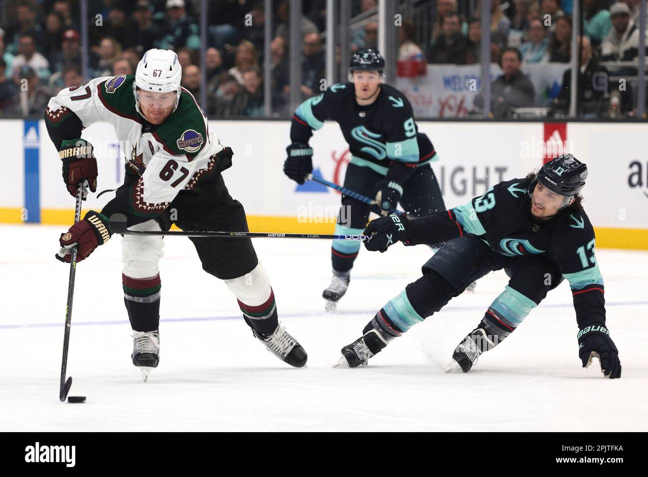 Arizona Coyotes left wing Lawson Crouse (67) moves the puck as Seattle ...