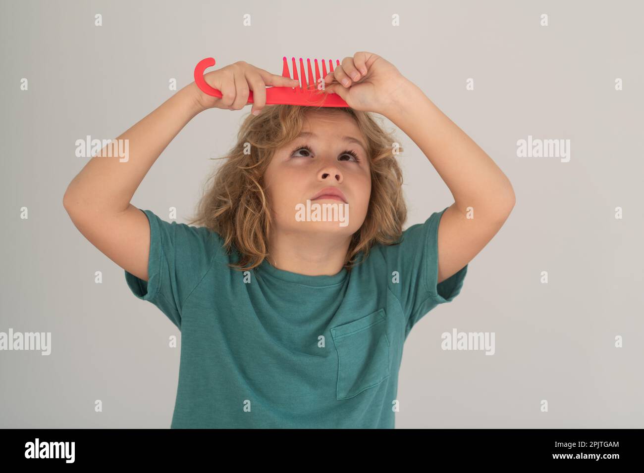 Kids barber shop. Little kid combing hair, isolated studio background ...