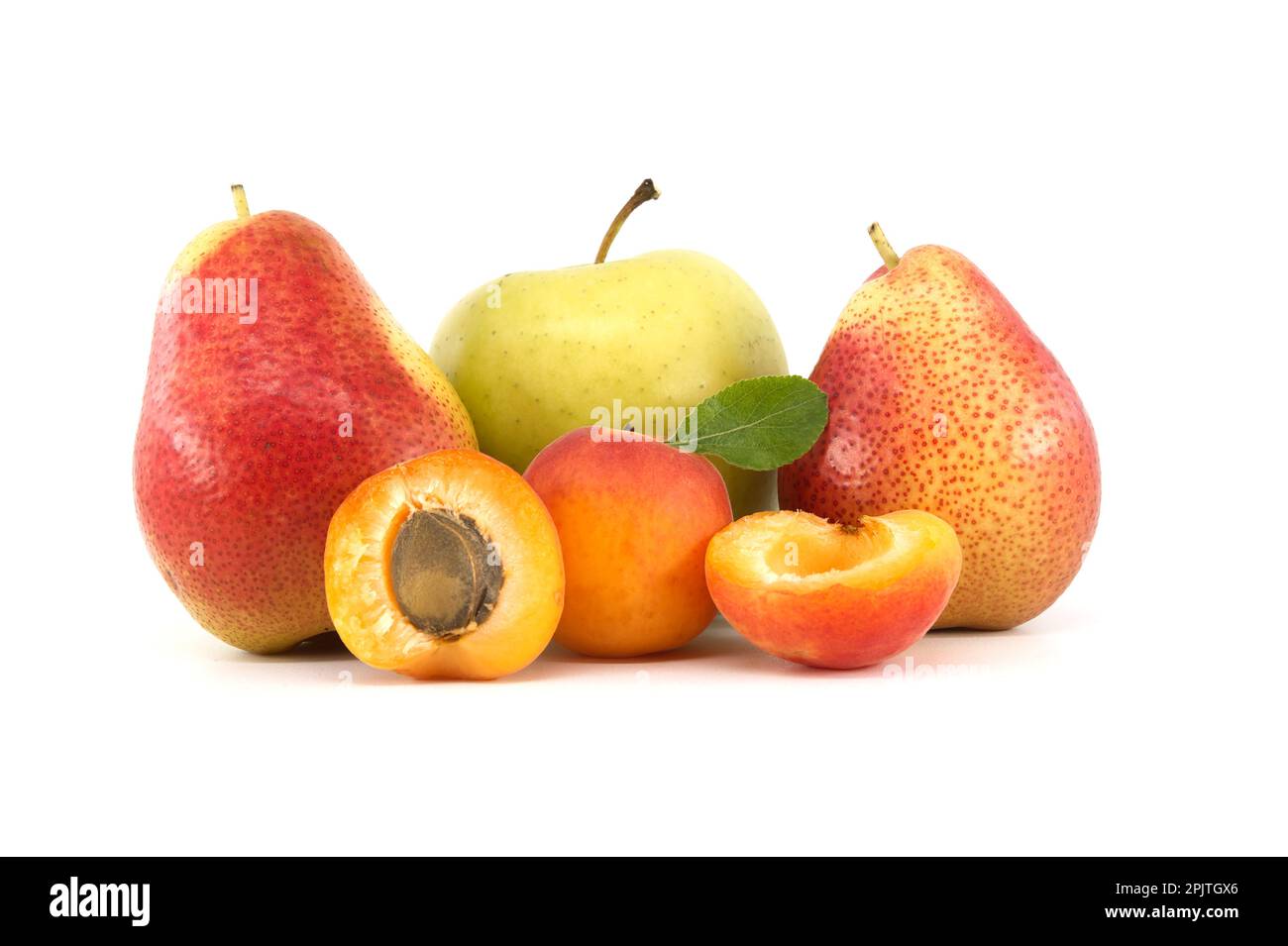 Whole and halved ripe apricots, multicolored pears and green apple ...