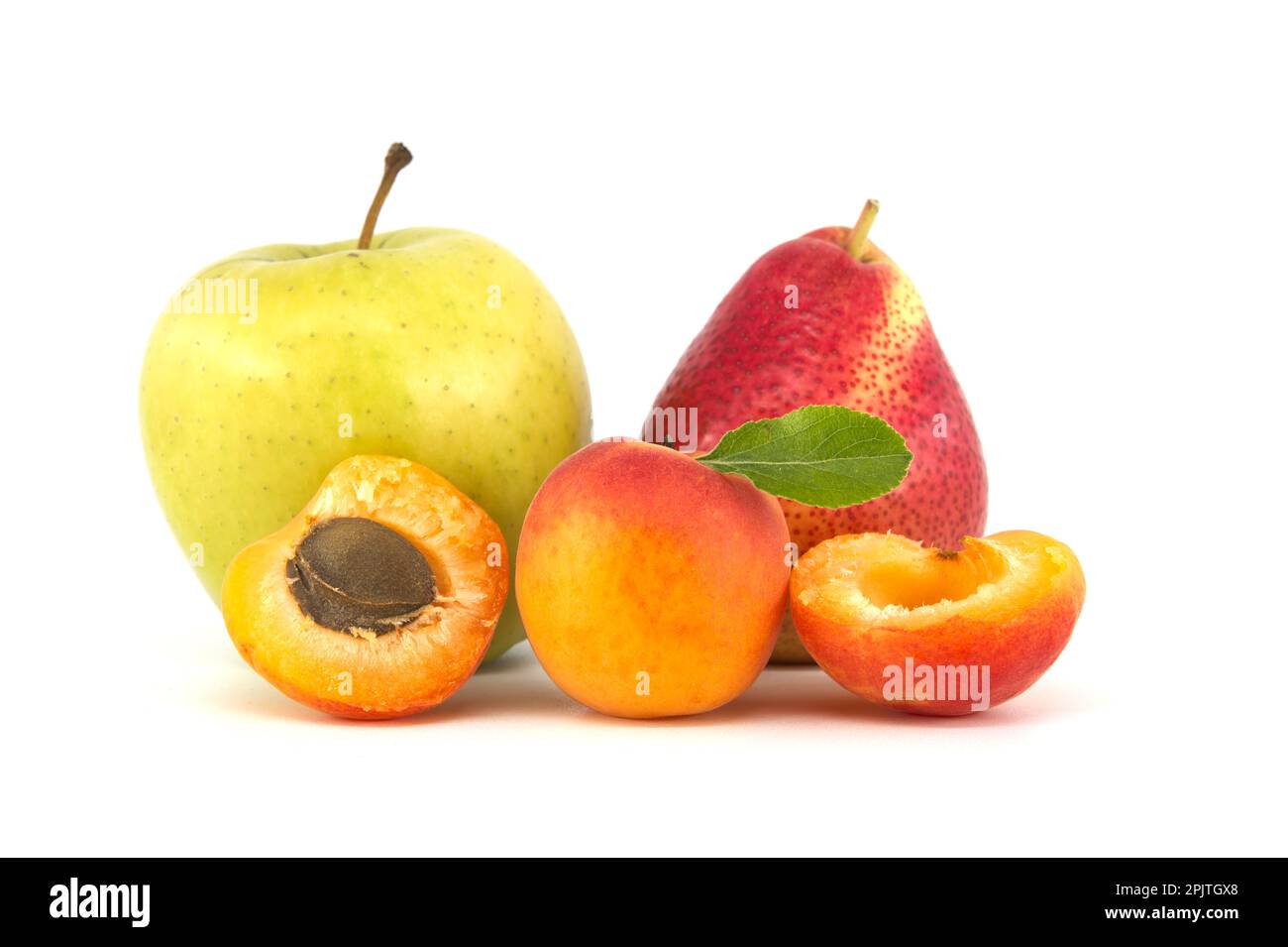 Whole and halved ripe apricots, multicolored pear and green apple ...
