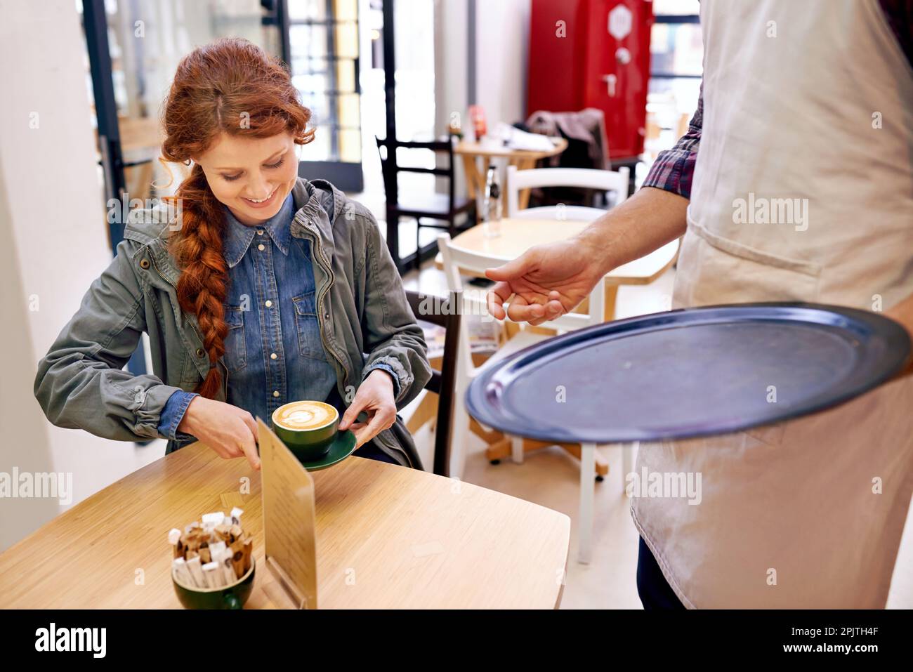 The perfect cup delivered to your table. a young woman ordering coffee ...