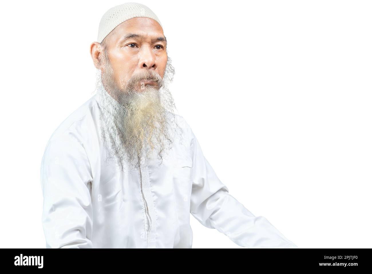 Muslim man with a beard wearing a white cap isolated over white ...