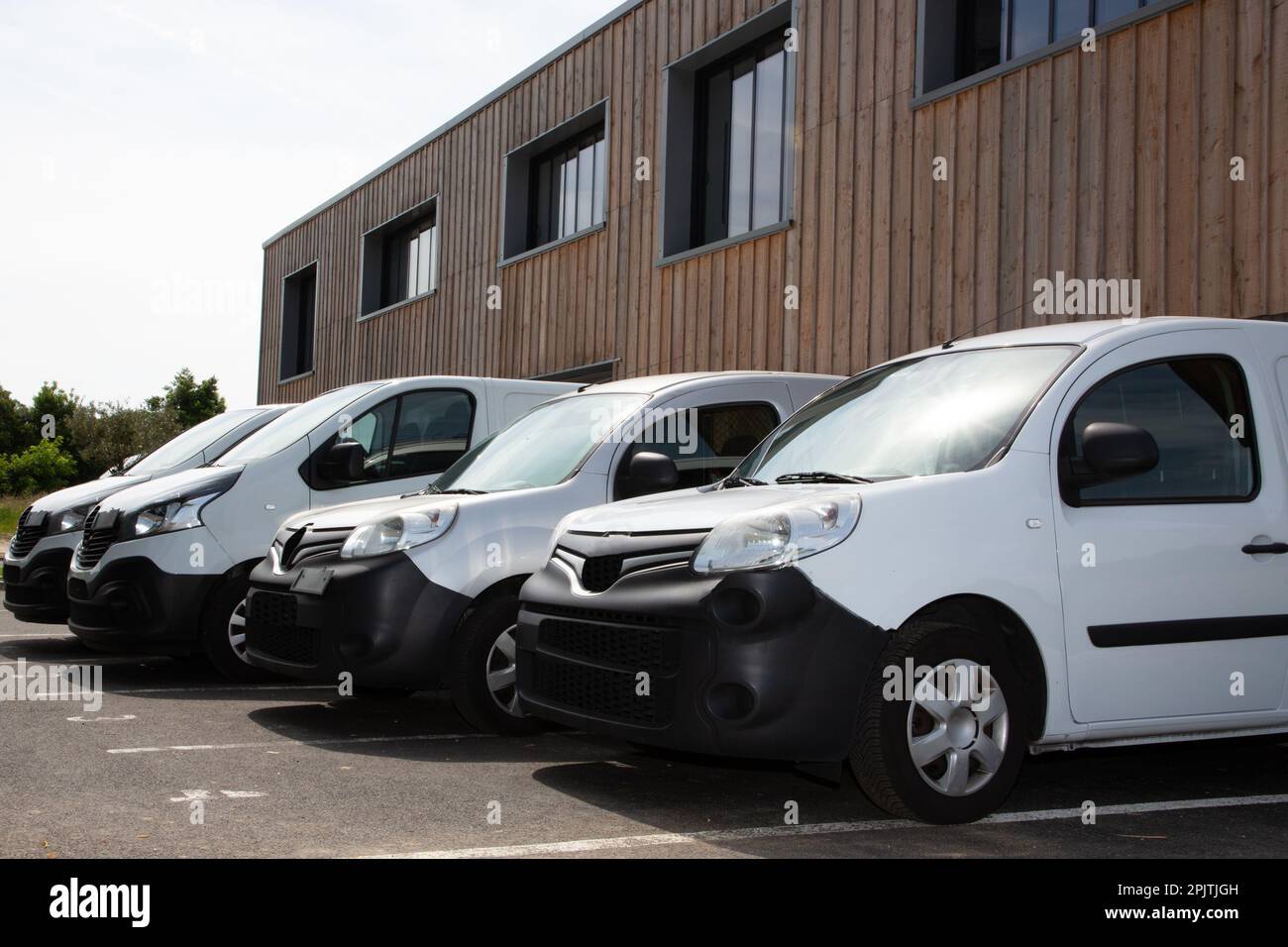 Row white delivery service van small trucks park front of factory ...