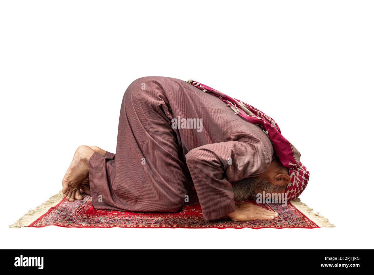 Muslim man with a beard wearing keffiyeh with agal in praying position ...