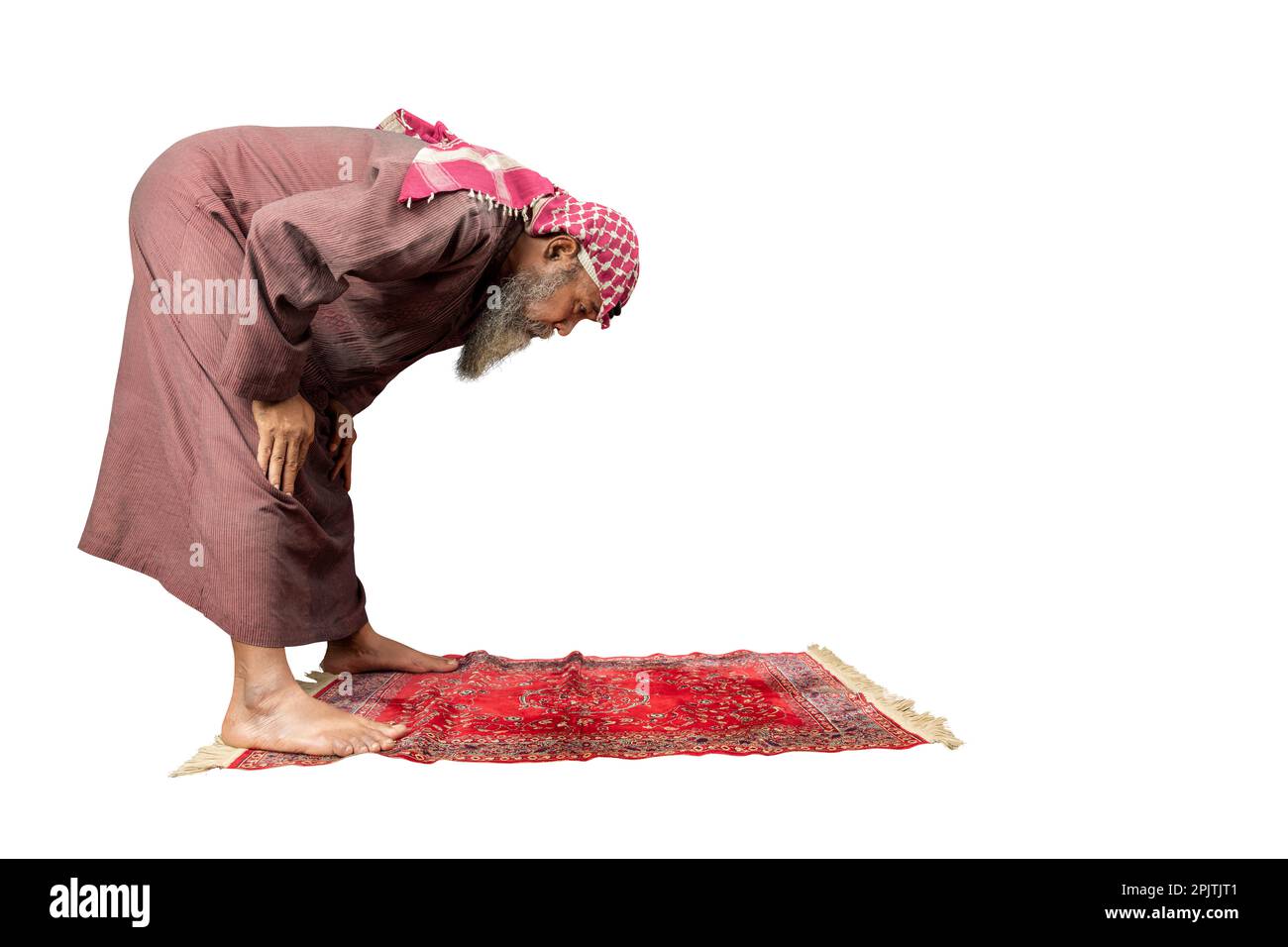 Muslim man with a beard wearing keffiyeh with agal in praying position ...