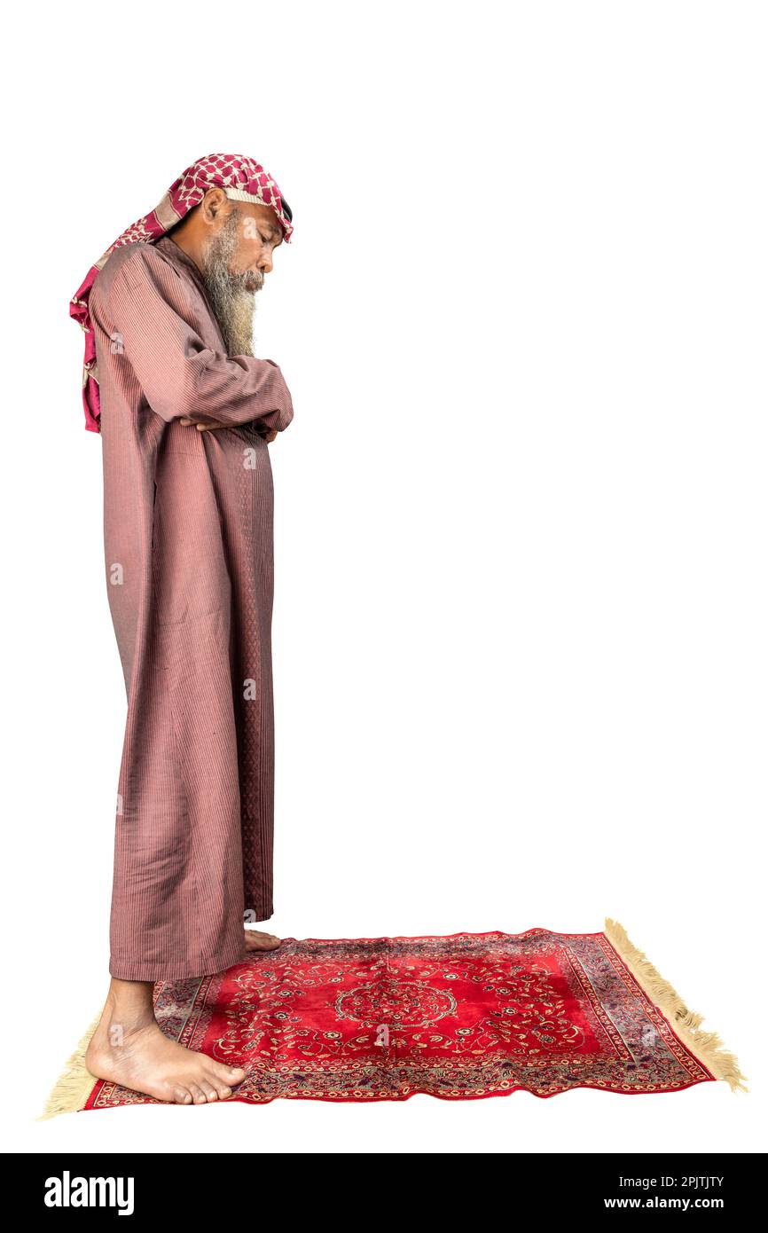 Muslim man with a beard wearing keffiyeh with agal in praying position ...
