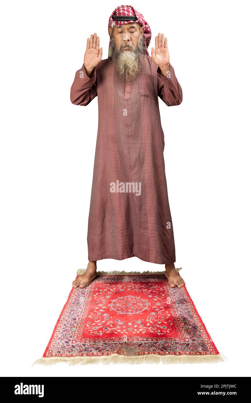 Muslim man with a beard wearing keffiyeh with agal in praying position ...