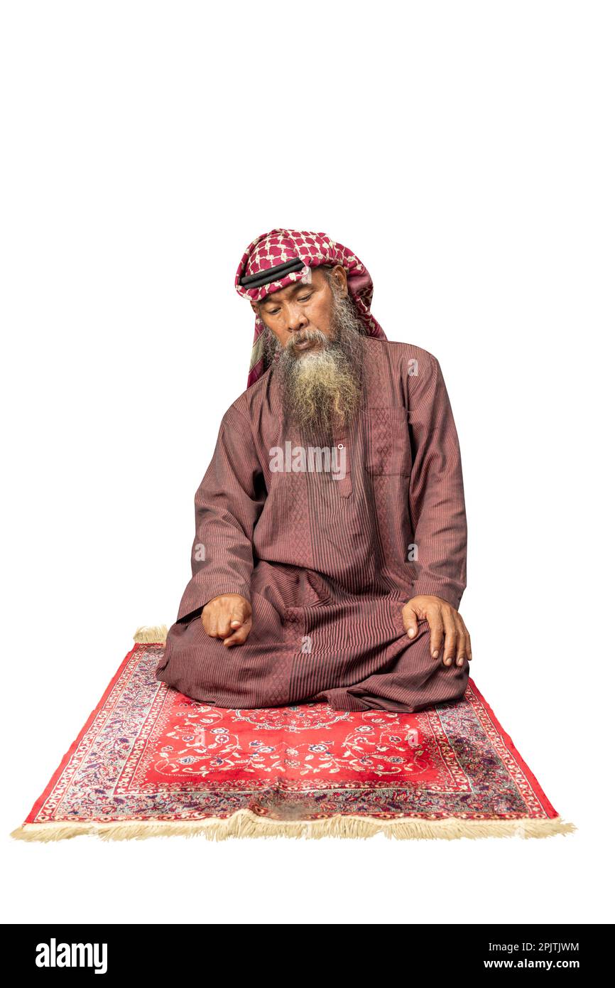 Muslim man with a beard wearing keffiyeh with agal in praying position ...