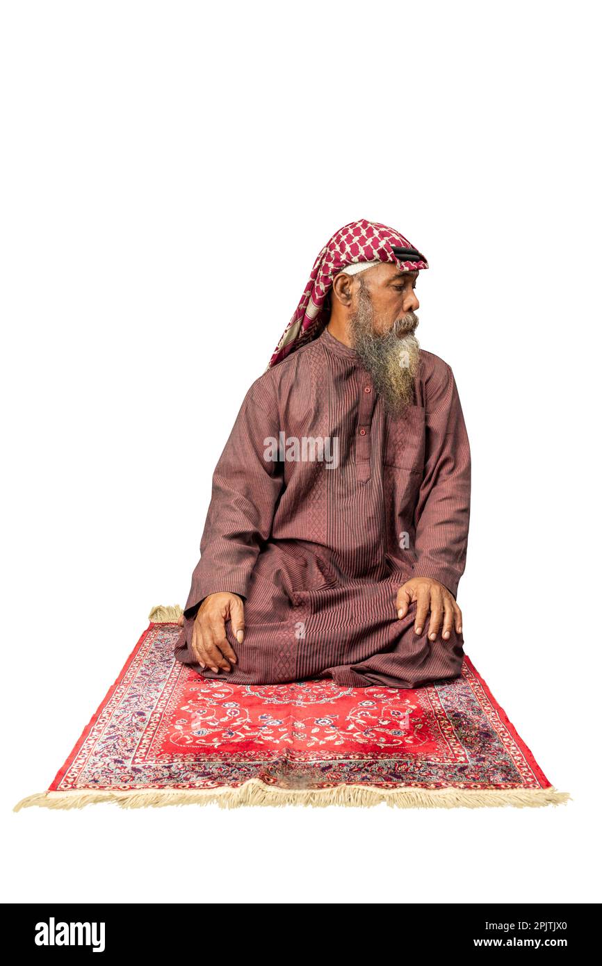Muslim man with a beard wearing keffiyeh with agal in praying position ...