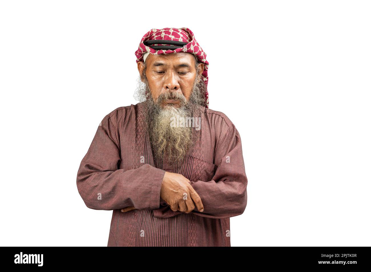 Muslim man with a beard wearing keffiyeh with agal in praying position ...
