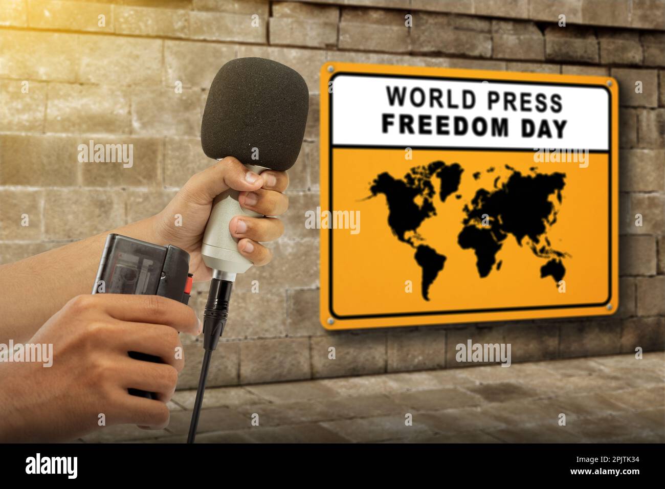 Human hand holding a microphone and recording device. World press freedom day concept Stock ...