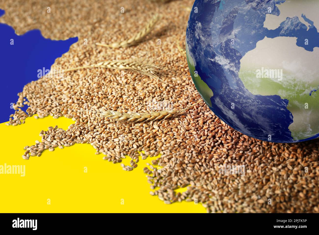 Global food crisis concept. Wheat grains and globe of Earth on table in ...