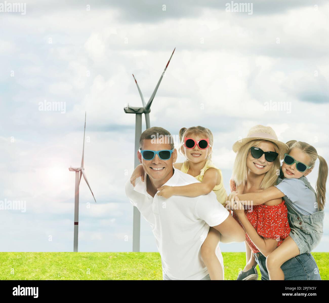 Happy family with children and view of wind energy turbines Stock Photo ...