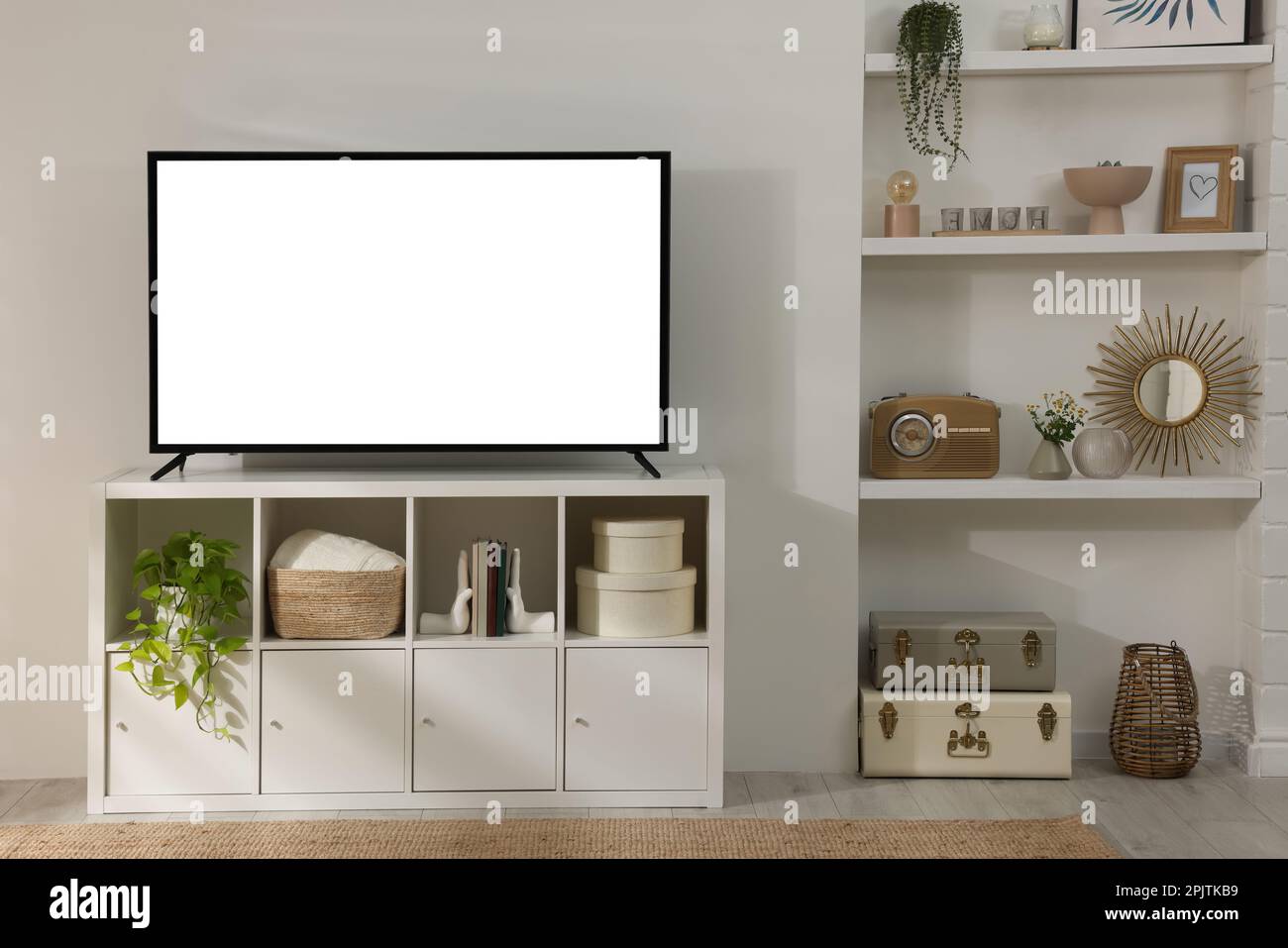 Modern TV set on stand in room Stock Photo - Alamy
