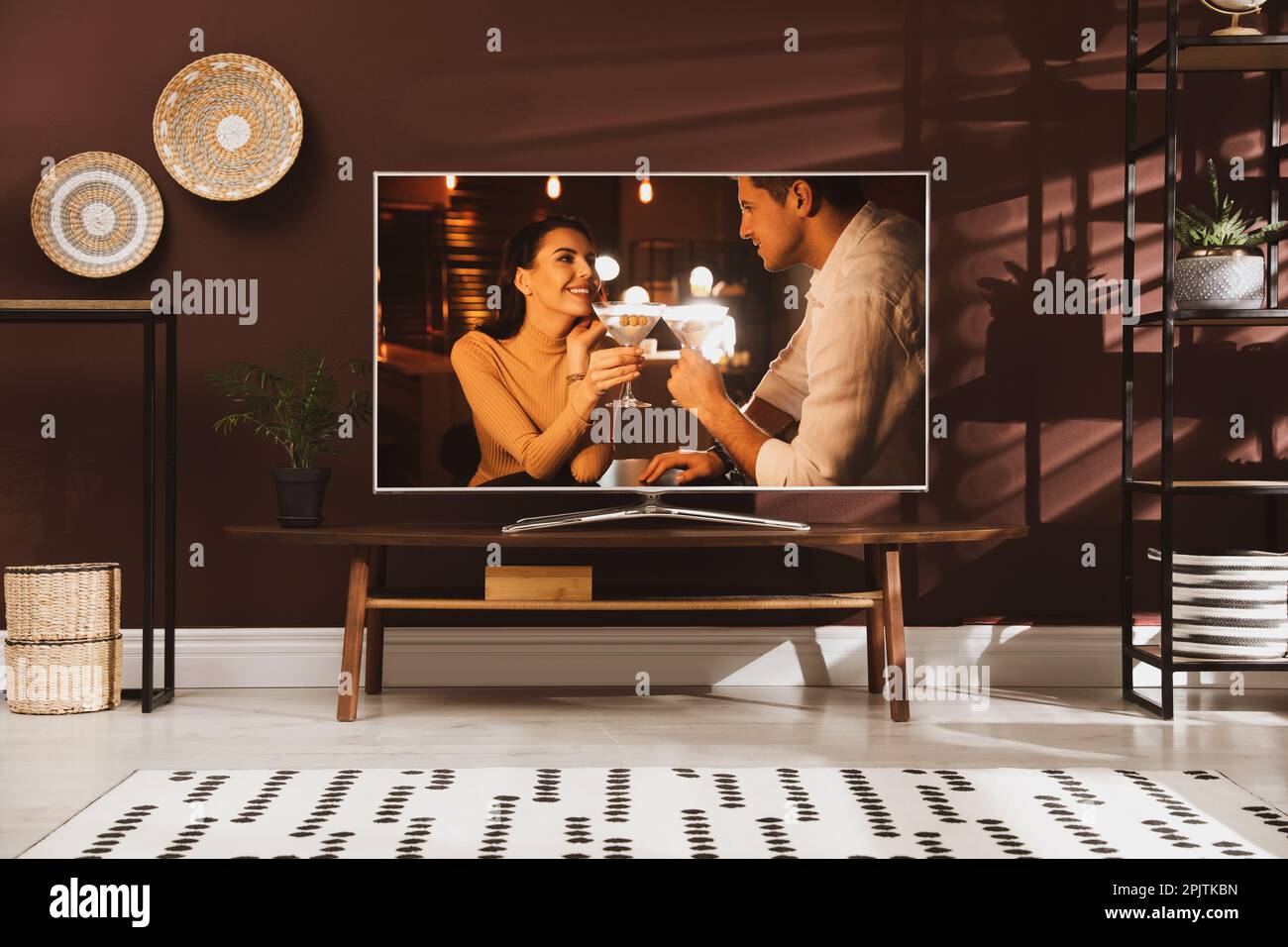 Scene of romantic movie on TV in room Stock Photo - Alamy