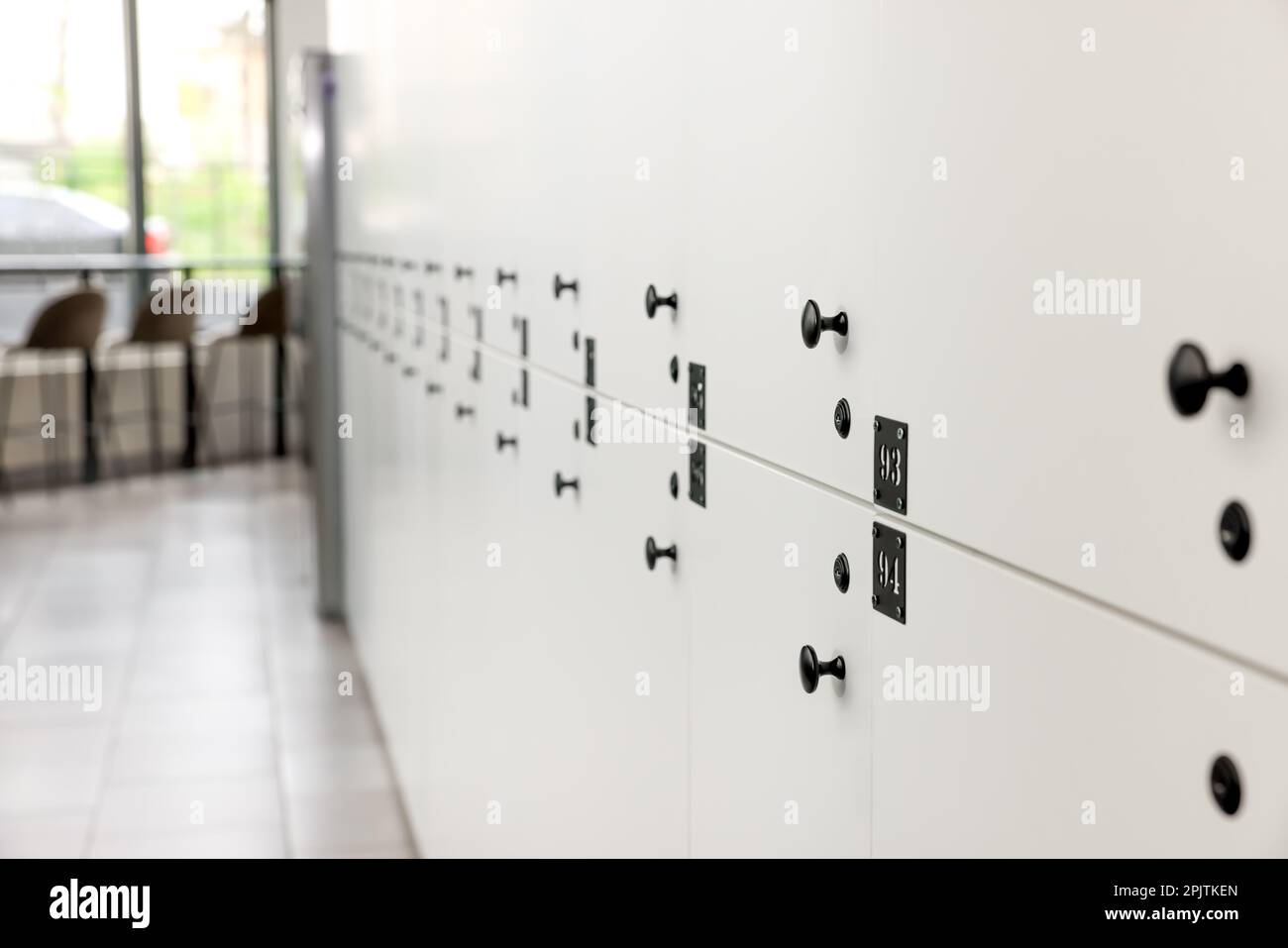 Rows of white lockers in modern hostel Stock Photo - Alamy