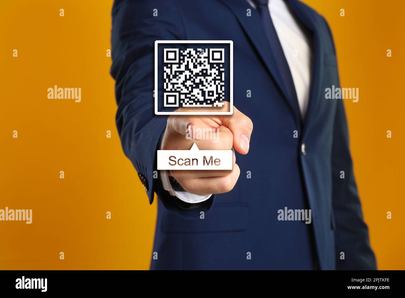 Man pointing at illustration of QR code on orange background, closeup ...