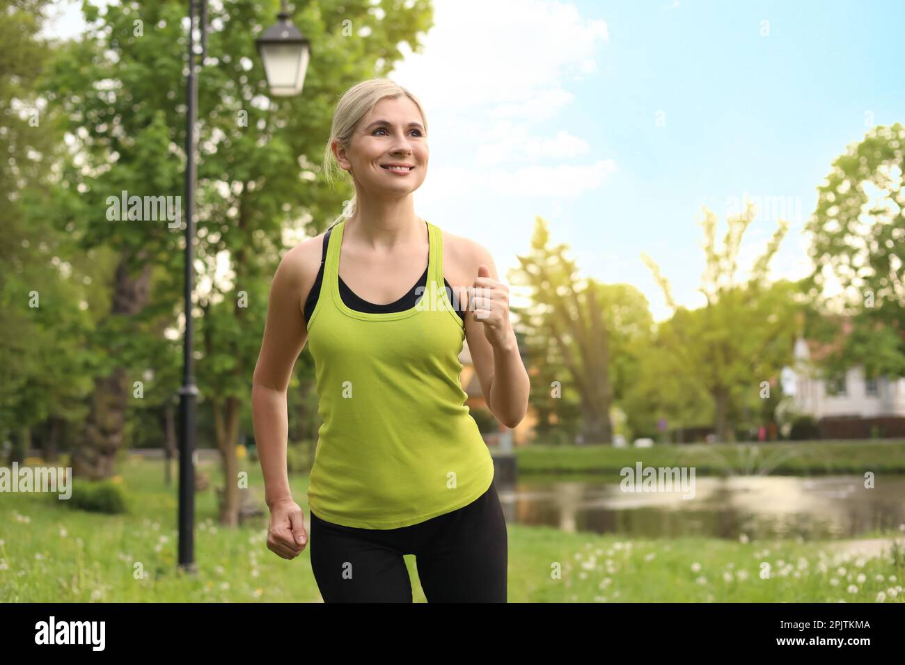 Beautiful woman jogging around park in morning Stock Photo - Alamy