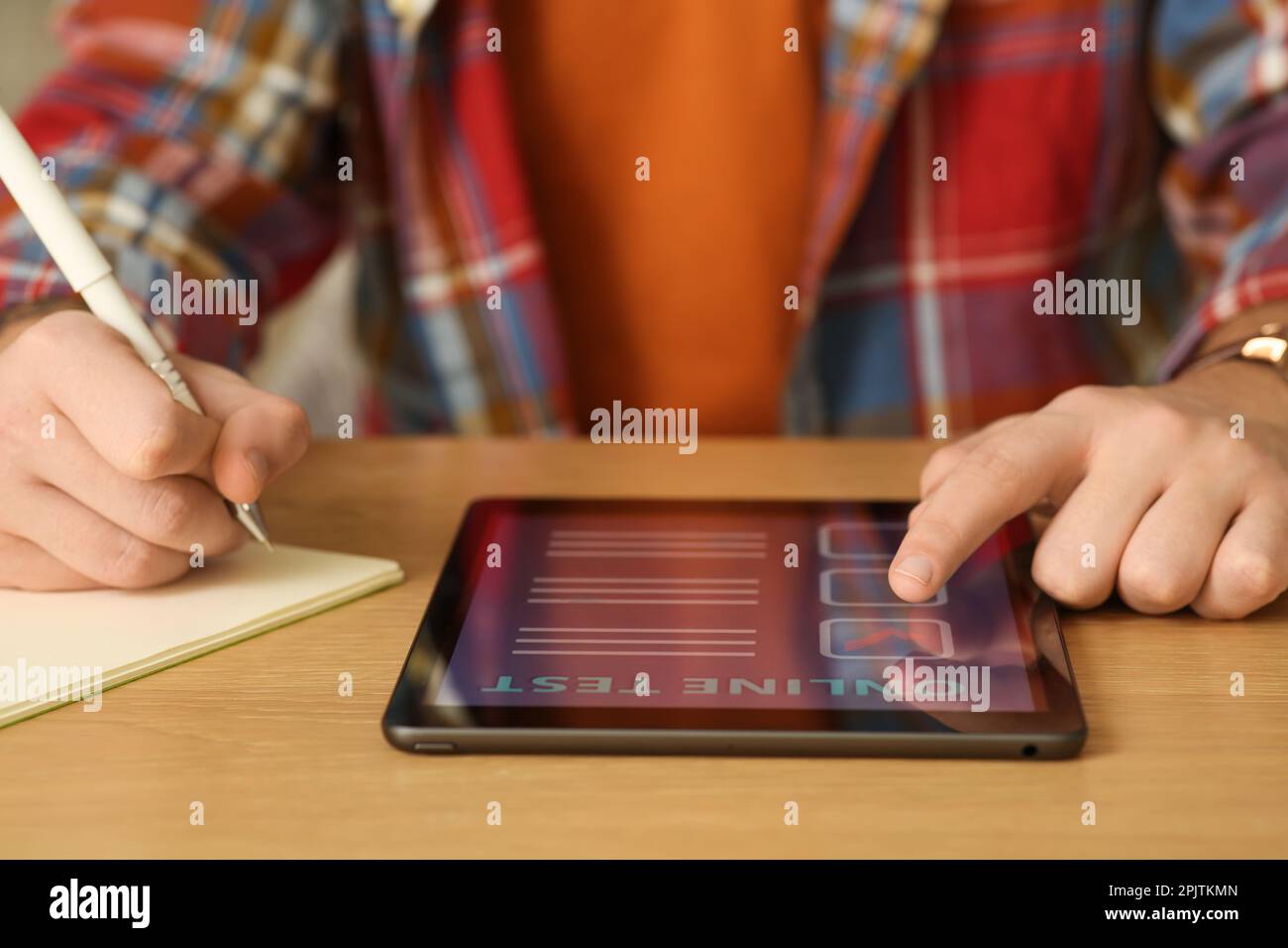 Hand taking exam on desk hi-res stock photography and images - Alamy