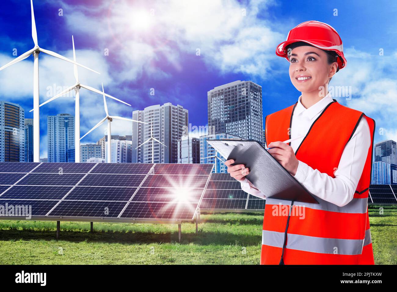 Industrial engineer in uniform and view of solar panels and wind energy ...