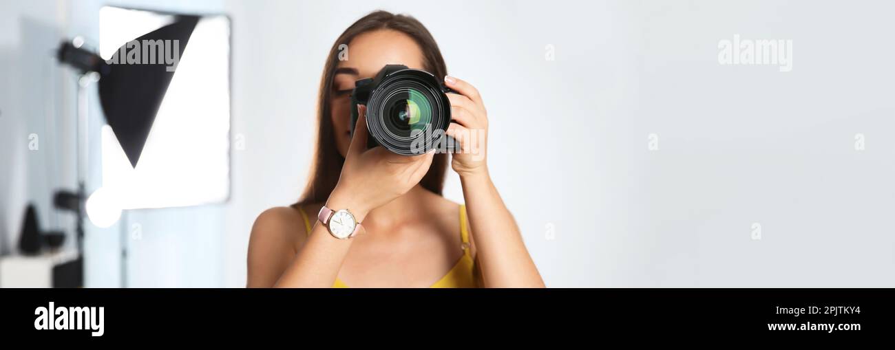 Professional photographer with camera in studio, space for text. Banner ...