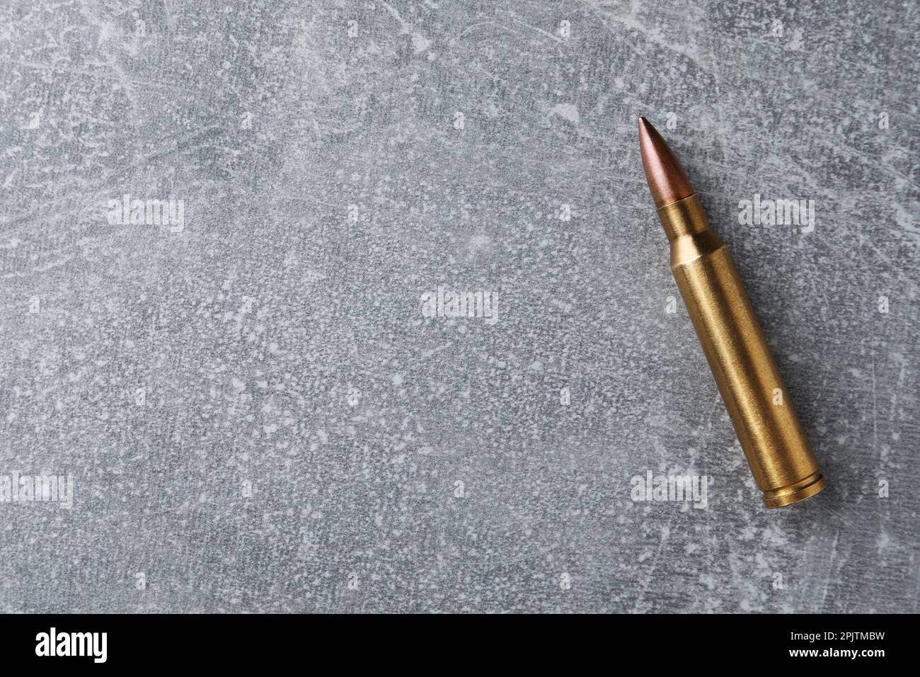 Bullet on light grey table, top view. Space for text Stock Photo - Alamy