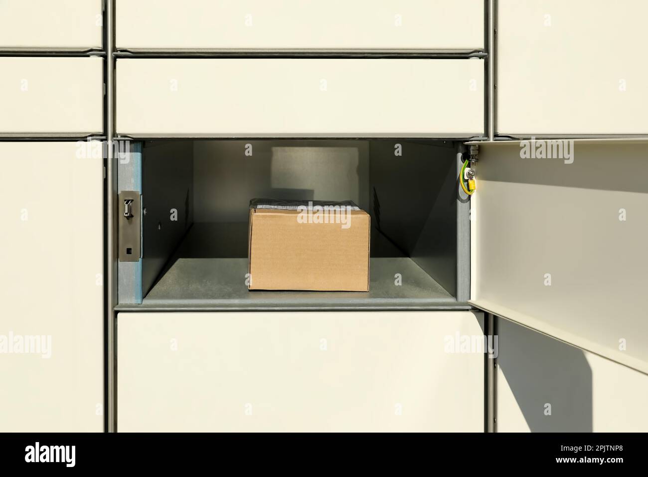 Open box with package in parcel locker Stock Photo - Alamy