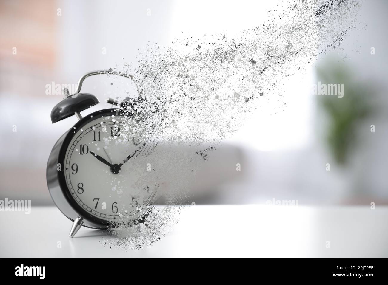 Time is running out. Black alarm clock vanishing on table in room Stock ...