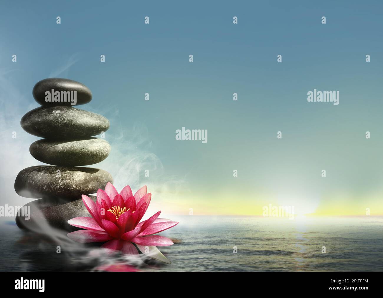 Zen, meditation, harmony. Beautiful lotus flower and stack of stones on ...