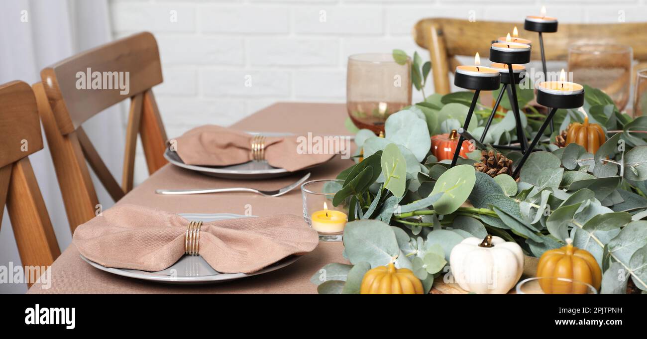 Autumn table setting with eucalyptus branches and pumpkins indoors ...