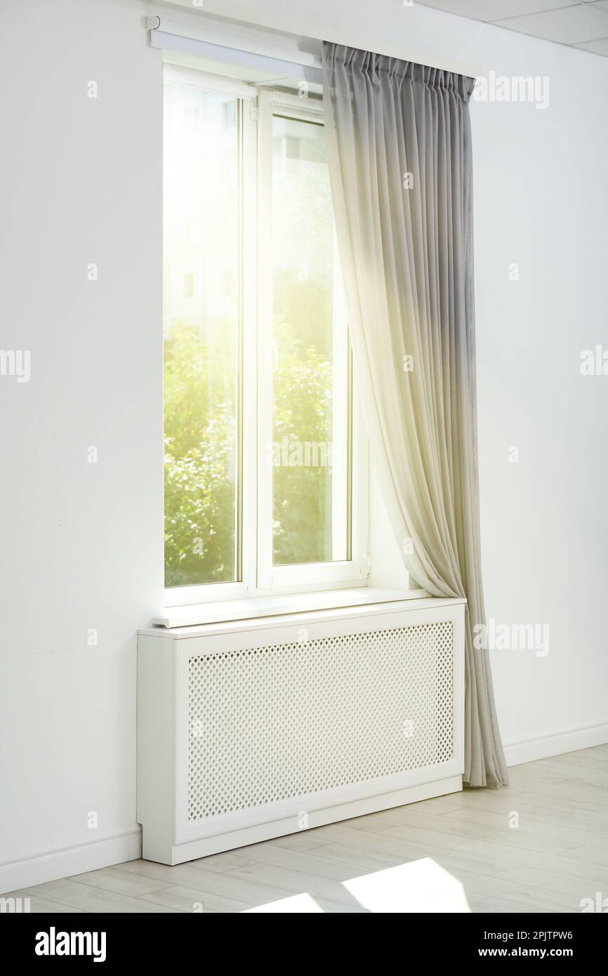 Bright sun shining through window with stylish curtain Stock Photo - Alamy