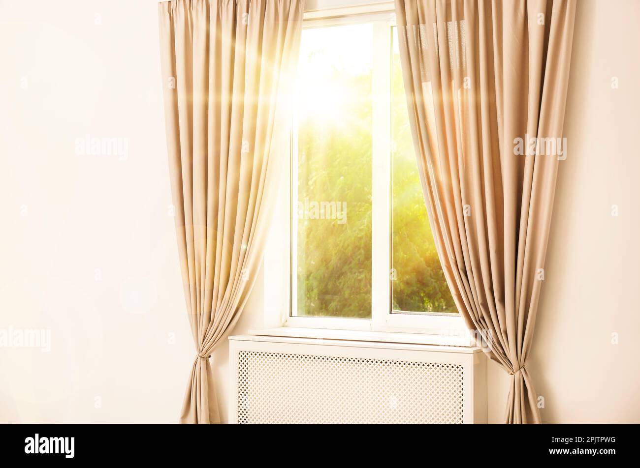 Bright sun shining through window with stylish curtains Stock Photo - Alamy