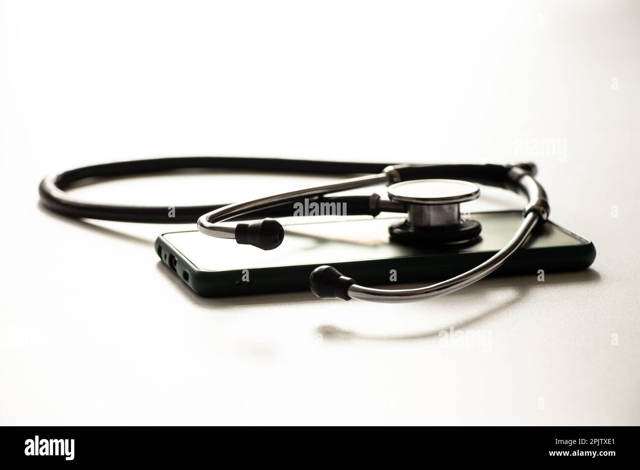 The stethoscope lies on a smartphone on a white background, online ...