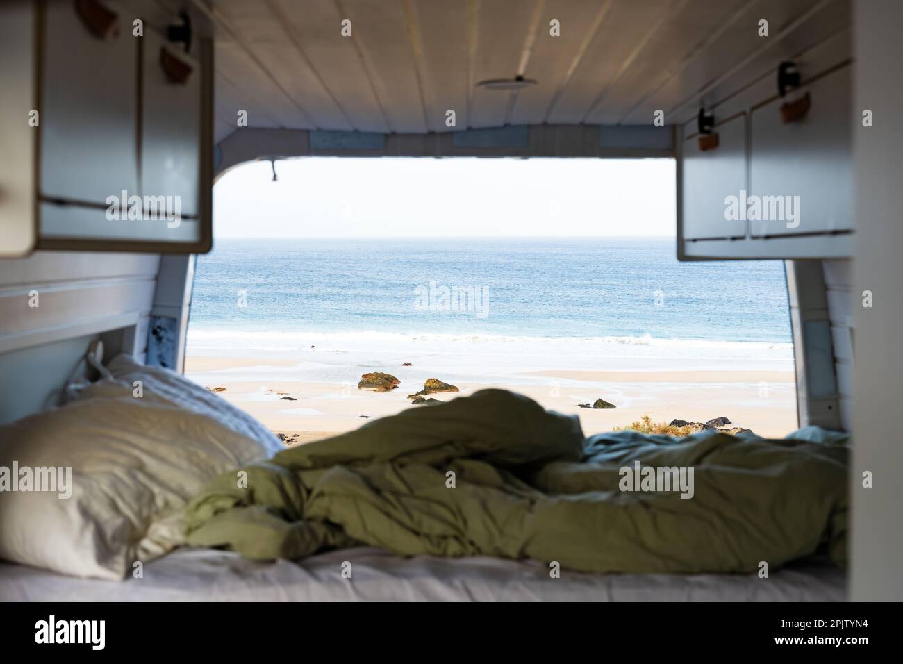 (Selective focus) View of the ocean from inside a van with a dismayed ...