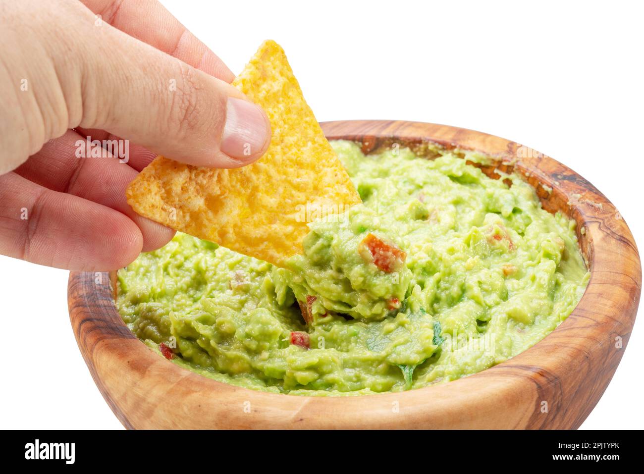 Dipping corn chips into guacamole on white background Stock Photo - Alamy