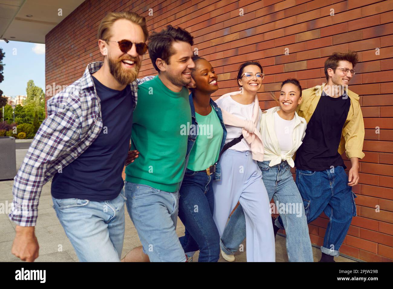 Group friends happily walking laughing hi-res stock photography and ...