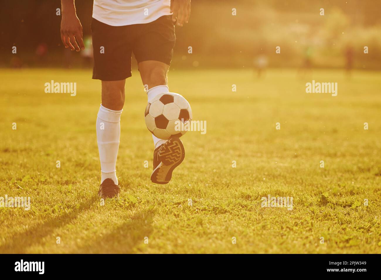 Beautiful sunshine. Young soccer player have training on the sportive ...